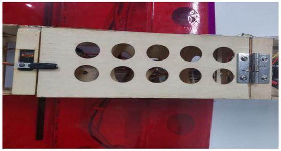Design and Control of an Ultra-Low-Cost Logistic Delivery Fixed-Wing UAV